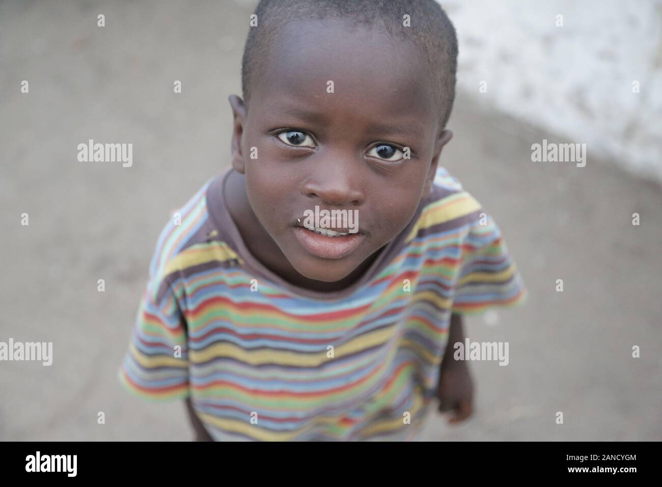 A young boy staring through the camera on the streets of Ghana Stock ...