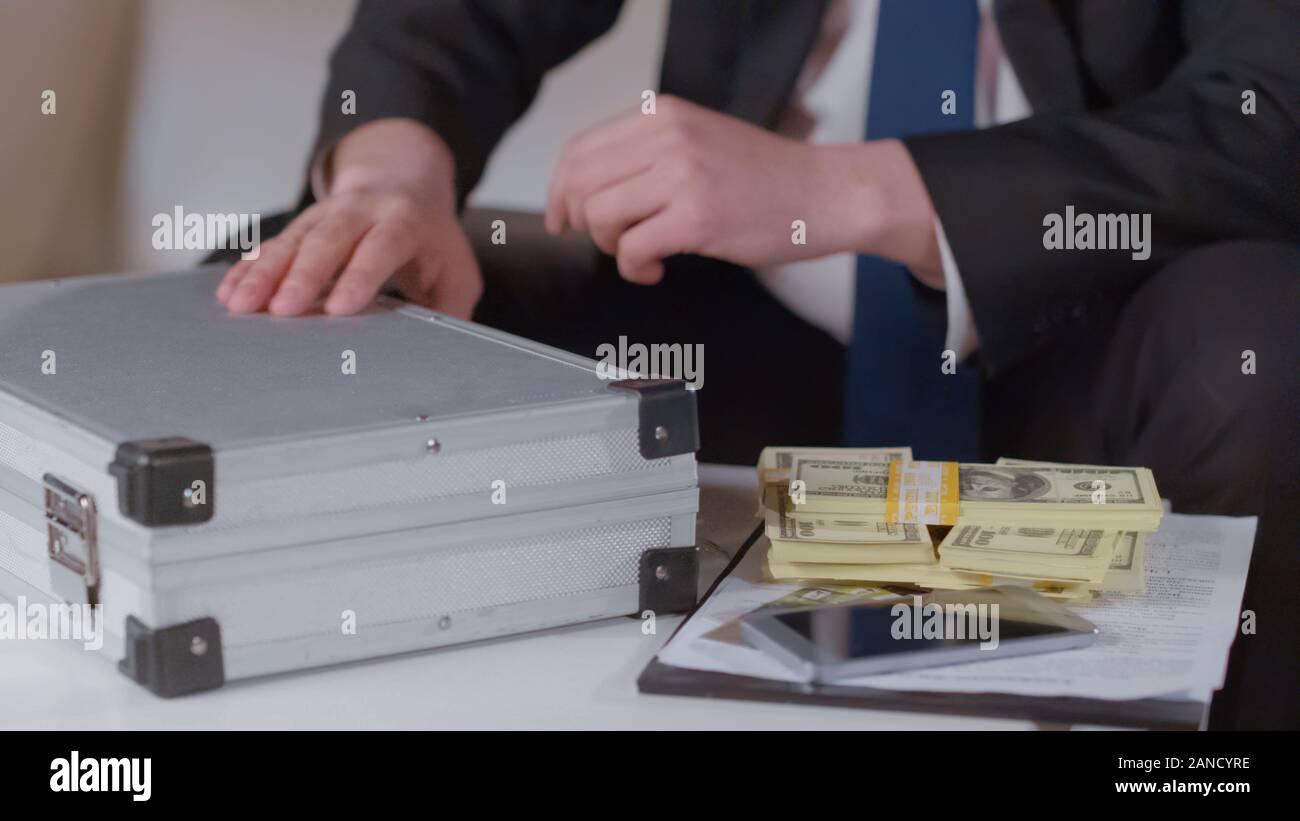 Entrepreneur getting money from briefcase, kickback for secret business ...