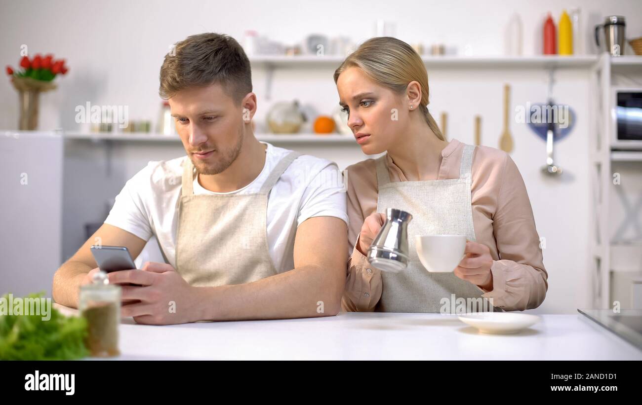 Miserable Wife Peeping At Husband Phone Male Texting With Lover