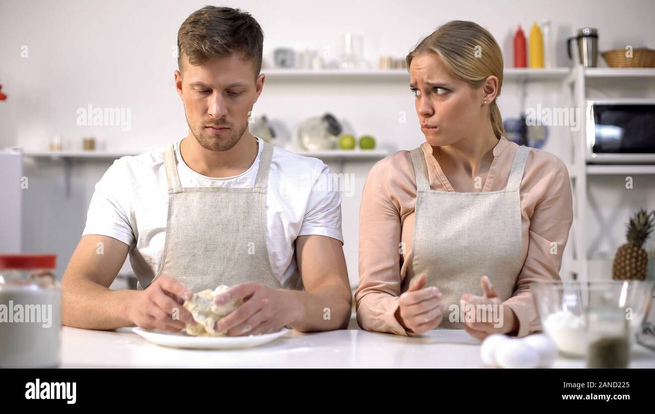 Male holding raw dough, wife looking awkwardly on husband, bad cook ...