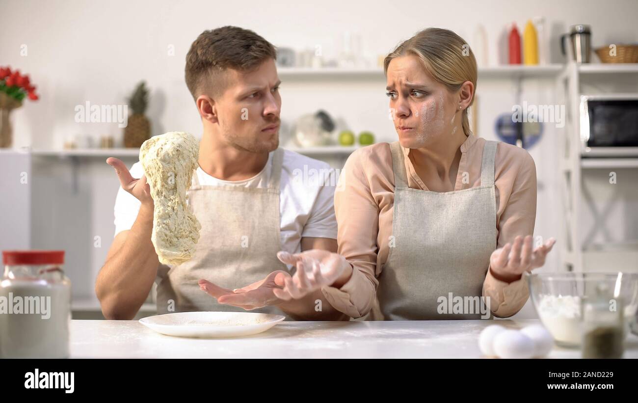 Master chef stretching raw dough, dissatisfied with work of new cook ...