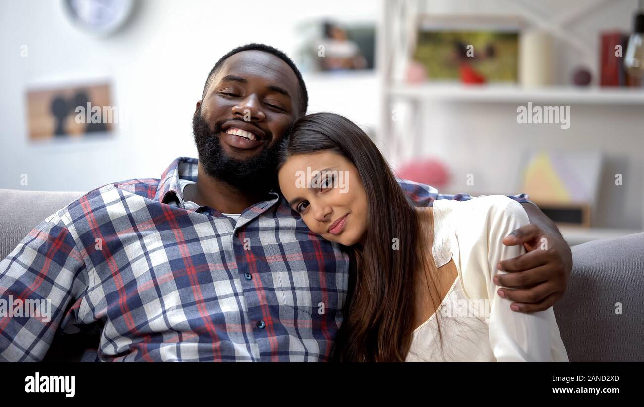 Couple hugging on sofa hi-res stock photography and images - Alamy