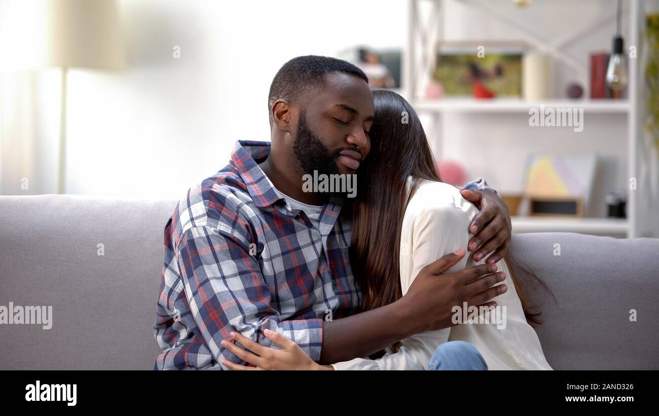 Couple cuddling on sofa hi-res stock photography and images - Alamy