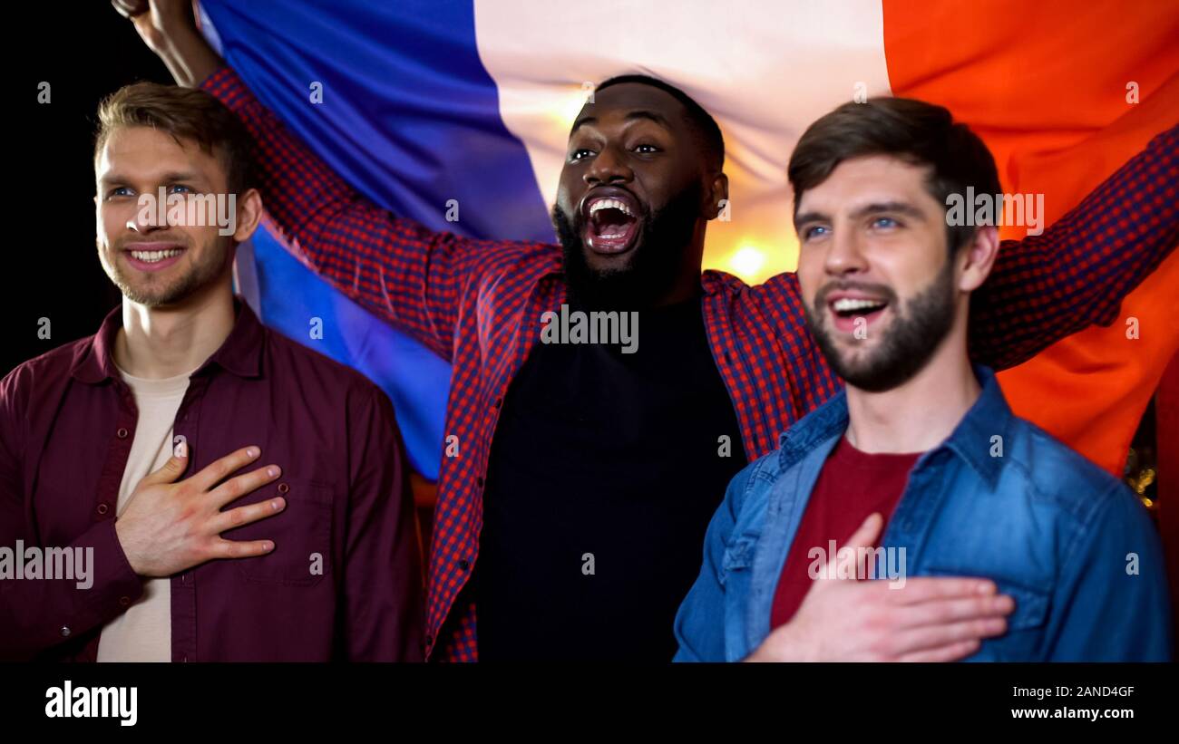 French national team supporters listening to anthem holding flag ...