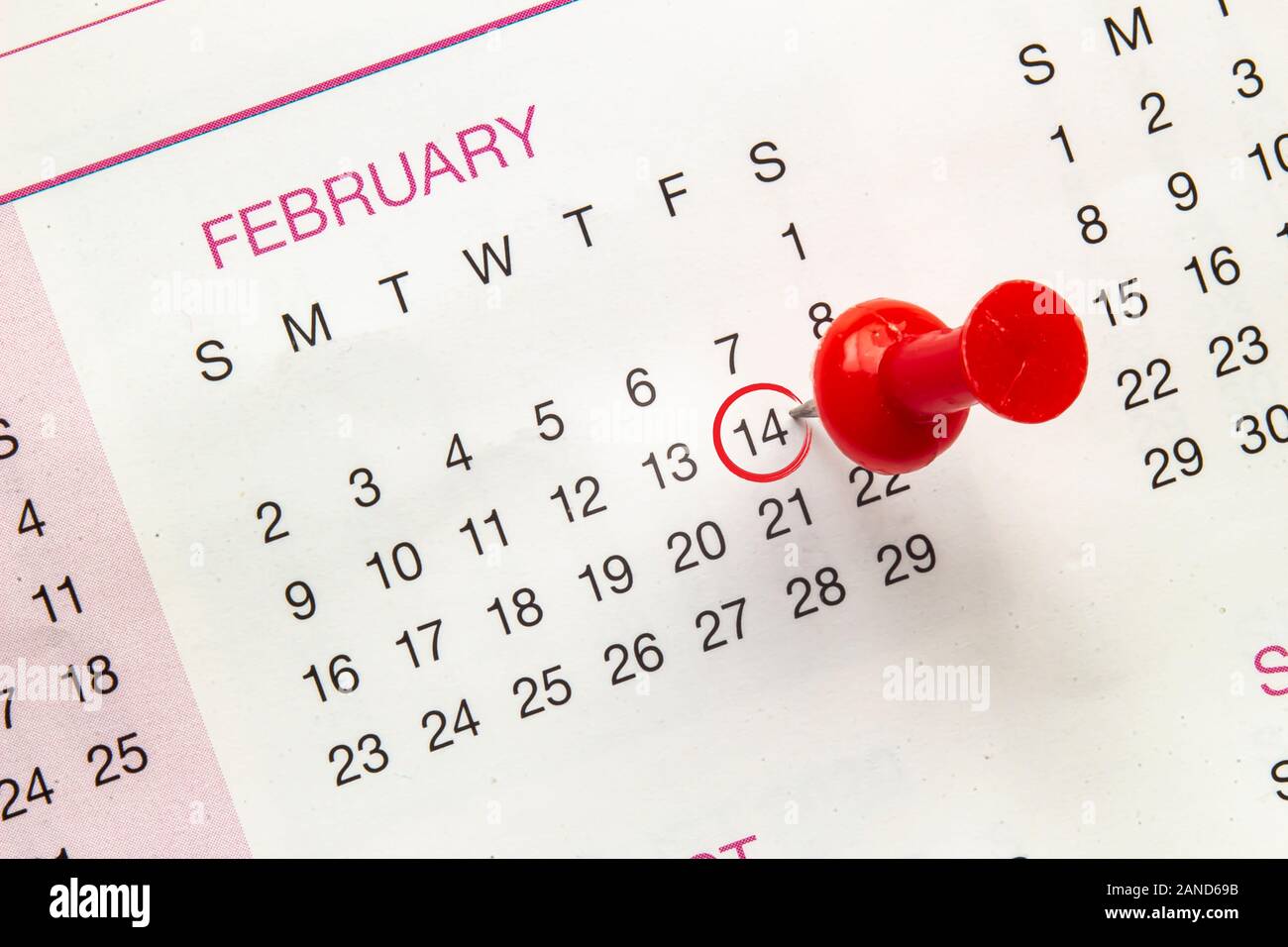 A close up to a calendar on February 14 with a pin and a red circle ...