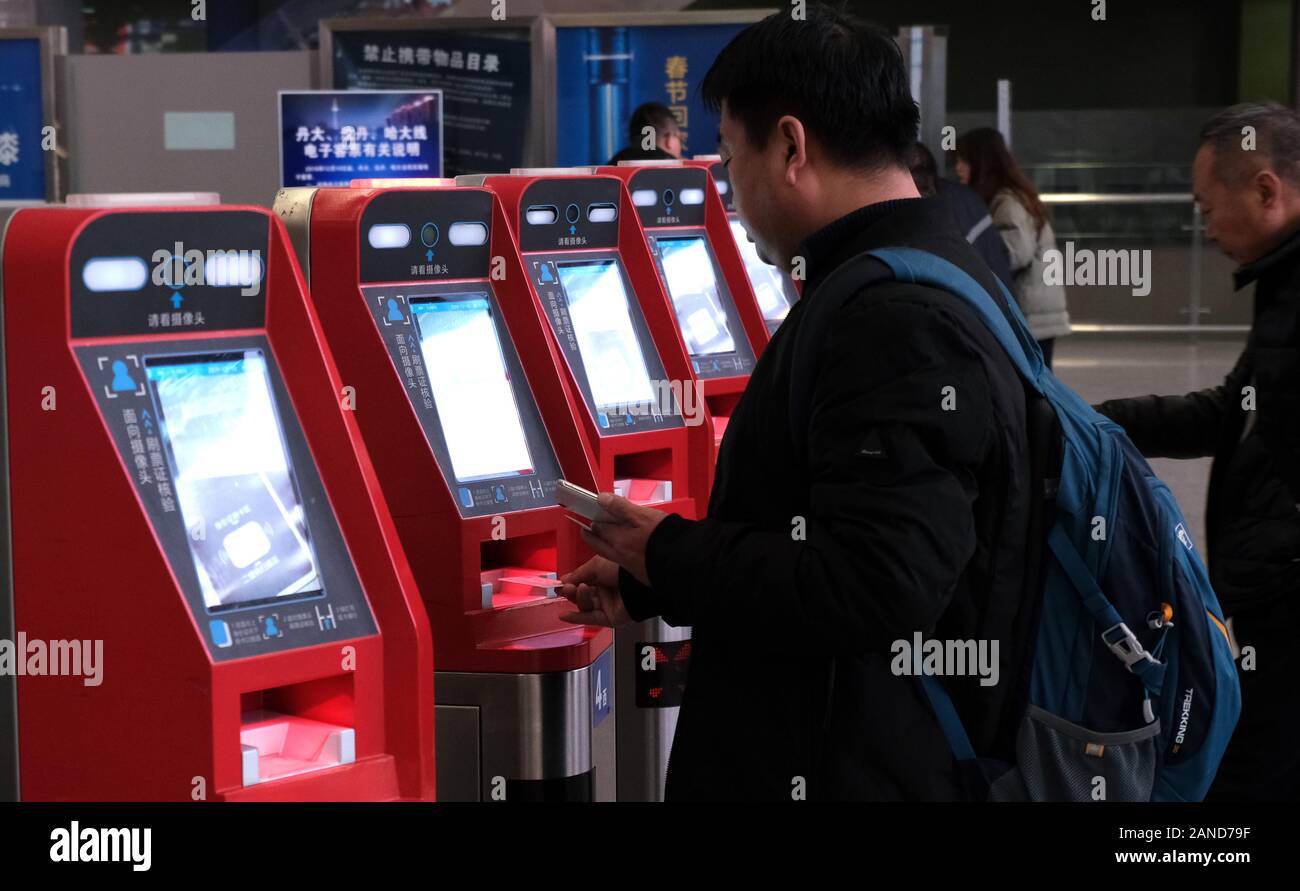 Passengers use ID card instead of paper ticket to board the train at ...