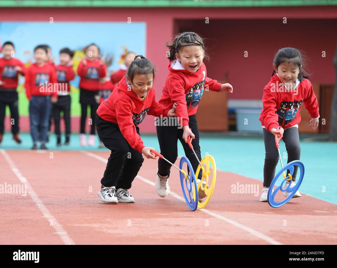 --File--A group of kids playing rolling loops, a type of traditional ...