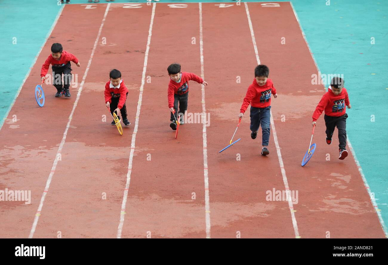 --File--A group of kids playing rolling loops, a type of traditional ...