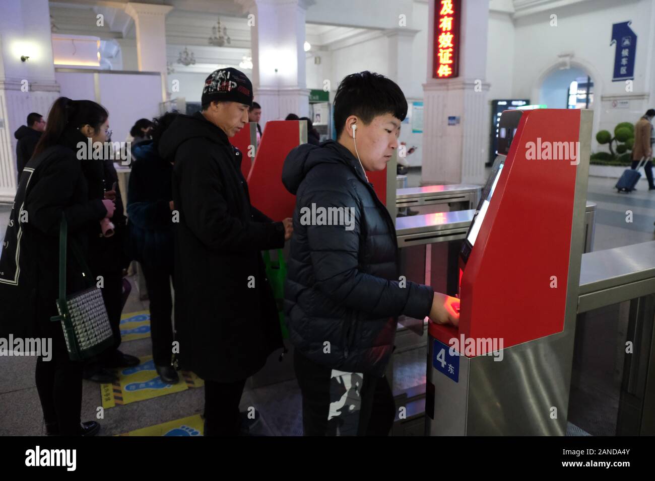Passengers use ID card instead of paper ticket to board the train at ...