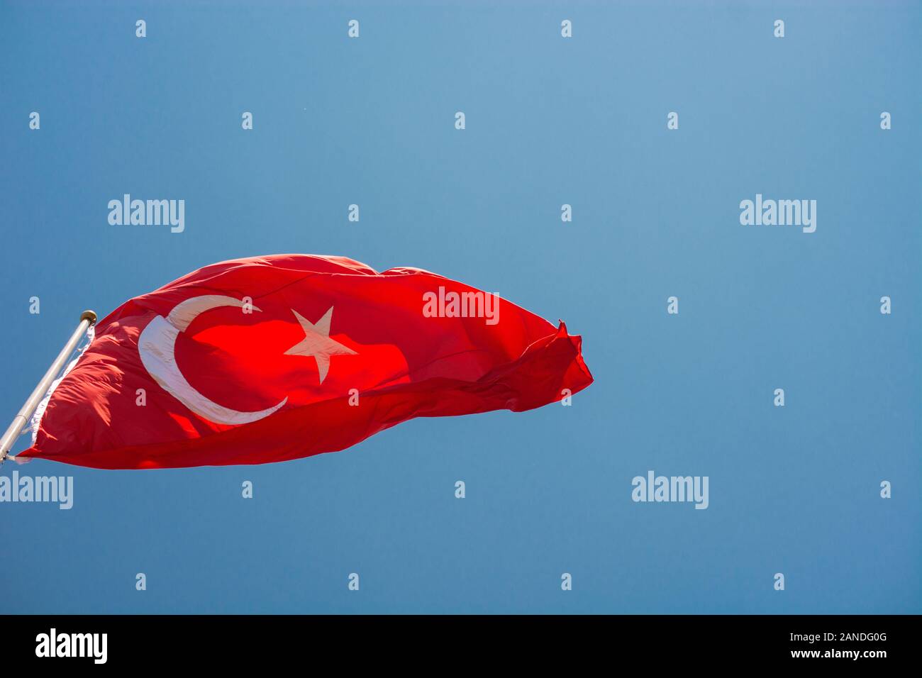 Turkish national flag with white star and moon on a pole in sky Stock ...
