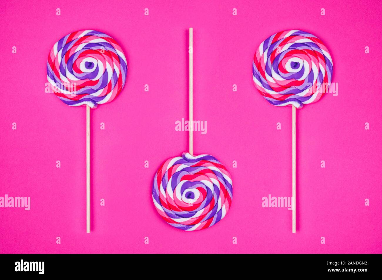 Big lollipops on solid pink background. Horizontal Stock Photo - Alamy