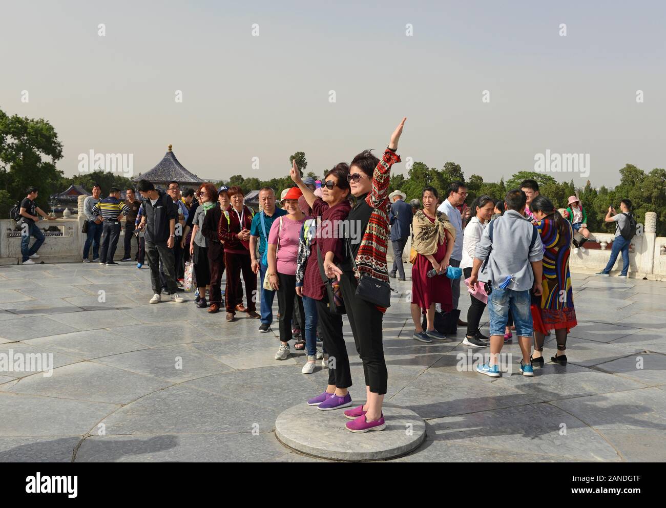 Visitors queue to have their photos taken on the Heart of Heaven stone ...