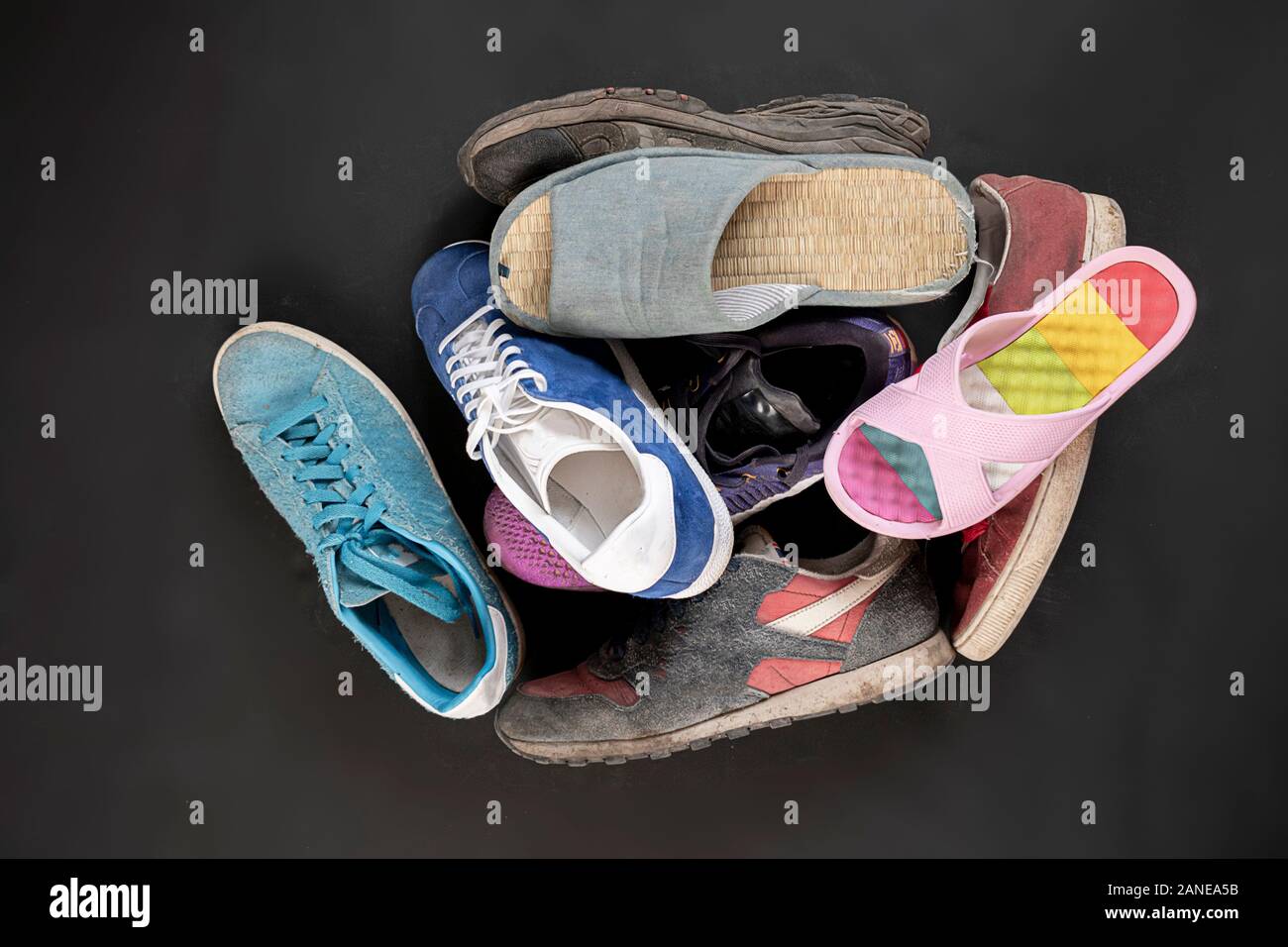 a bunch of new and used shoes, mix of differetn models pair on black ...