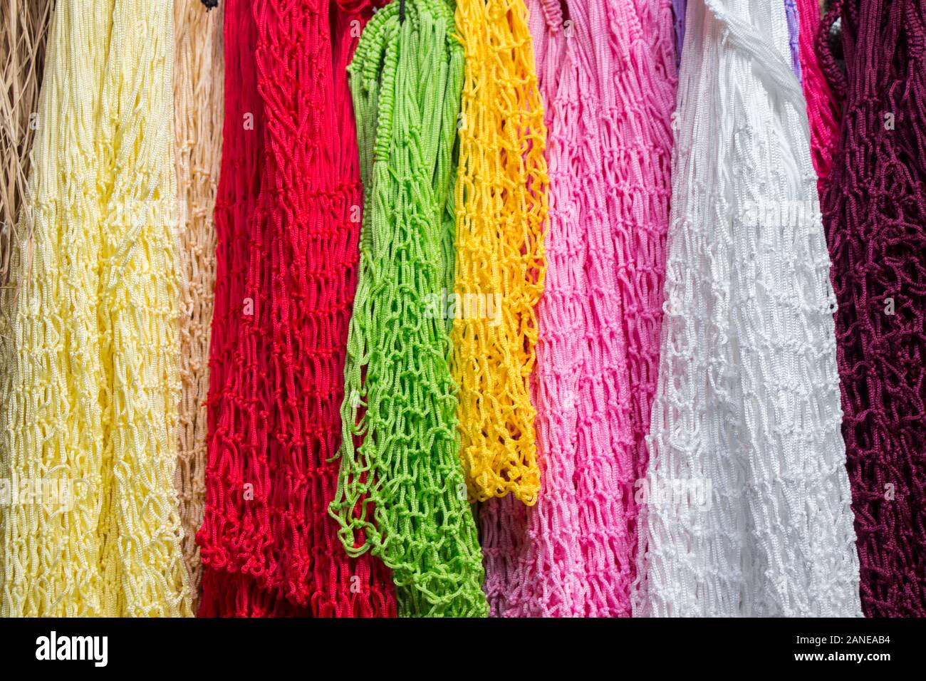 Empty mesh bags of various color at a market place Stock Photo - Alamy