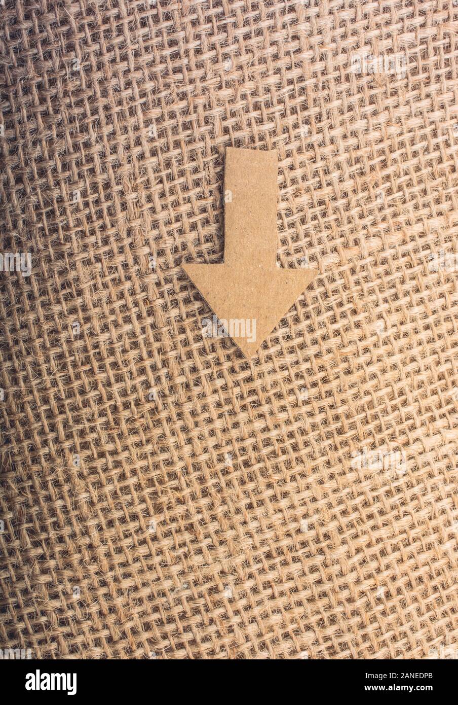 Arrow sign cut out of brown paper on canvas Stock Photo - Alamy