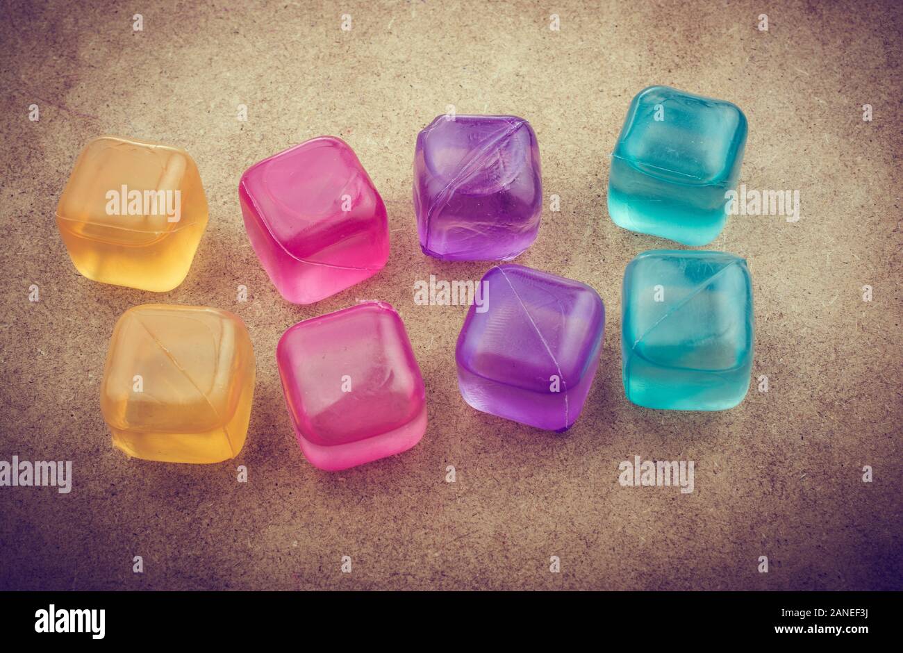 Fake colorful ice cubes on a brown background Stock Photo - Alamy