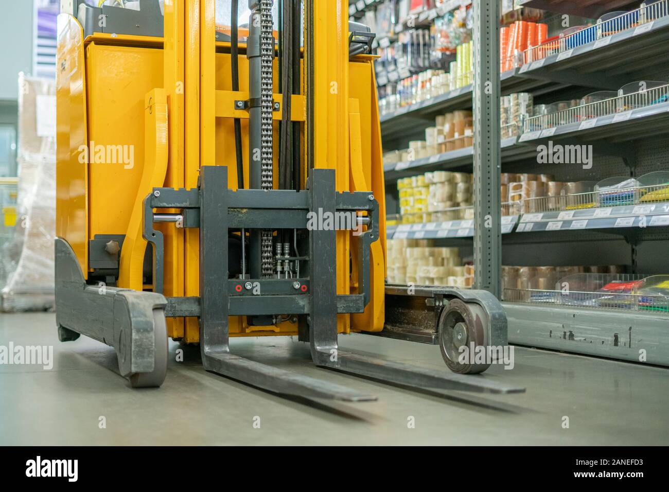 a forklift in the warehouse working and lifting the boxes of new income ...