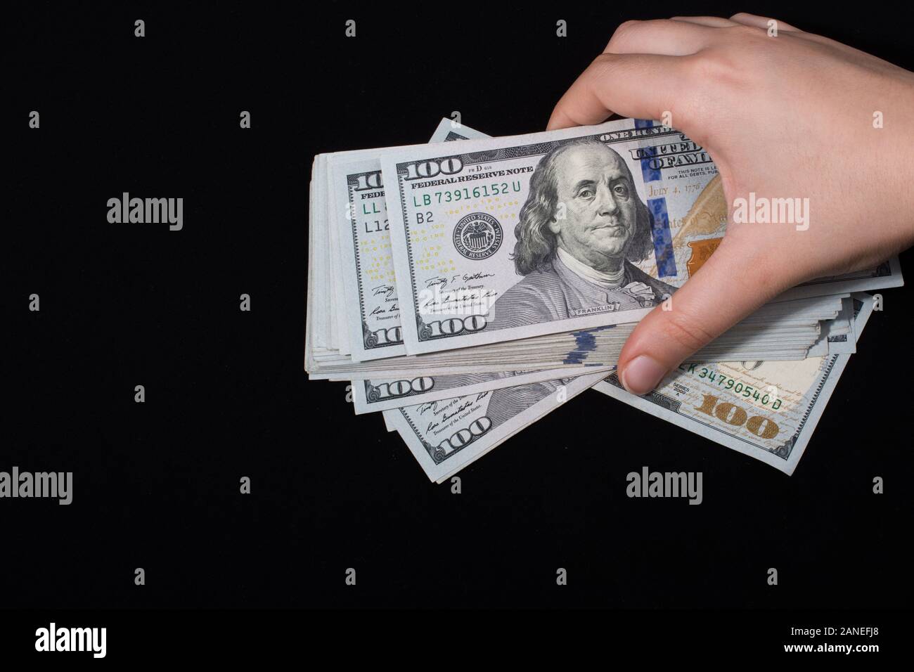 Hand holding American dollar banknotes isolated on white background ...