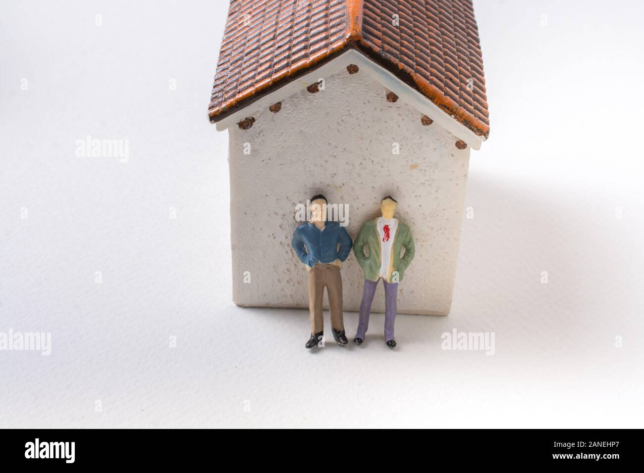 Tiny figurine of man miniature before a house Stock Photo - Alamy