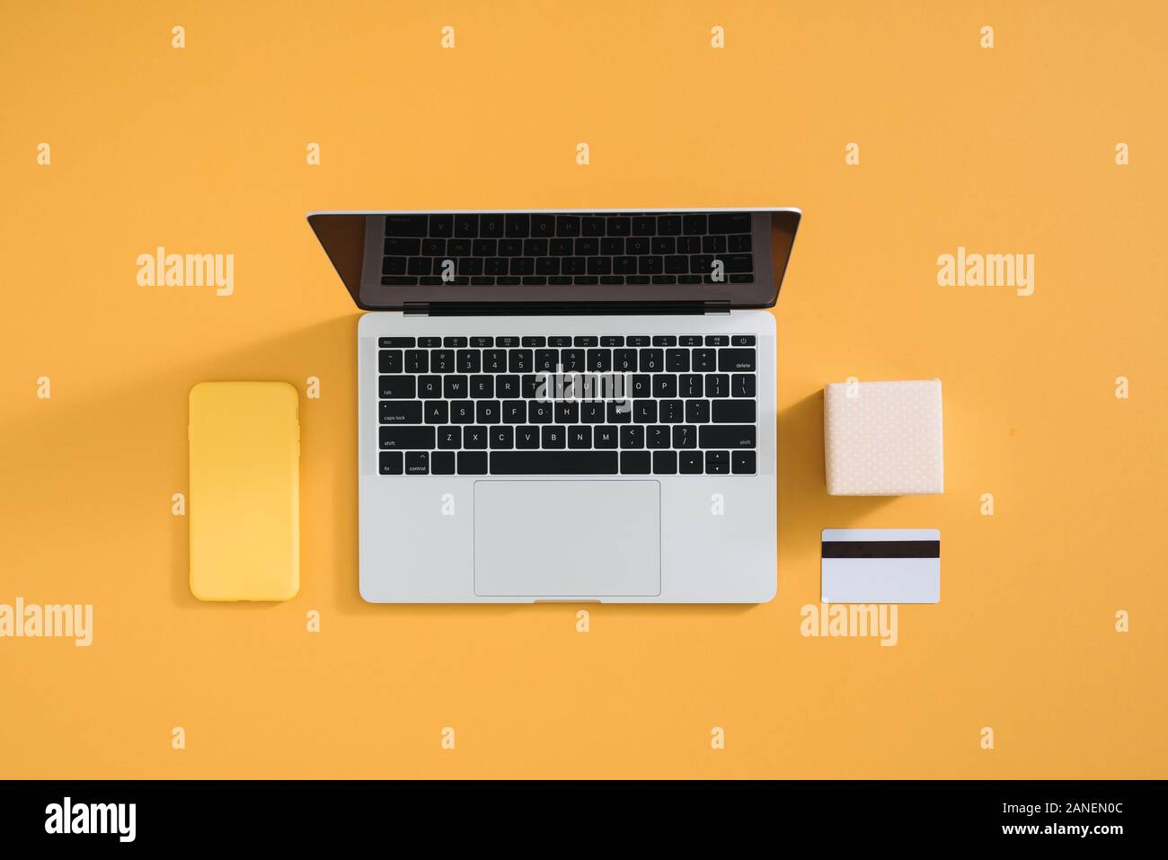 Laptop with cellphone and gift box with payment card in colors. Concept ...
