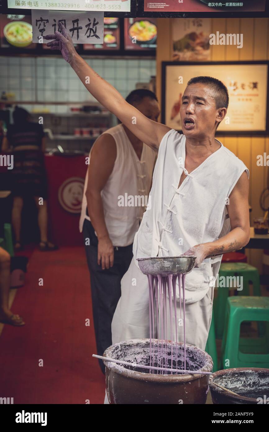 Chongqing, China - August 2019 :Male chef preparing and making ...