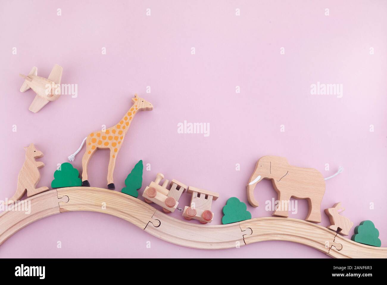 Zero waste. Eco wooden toys on pink background. Flat lay. Top view ...