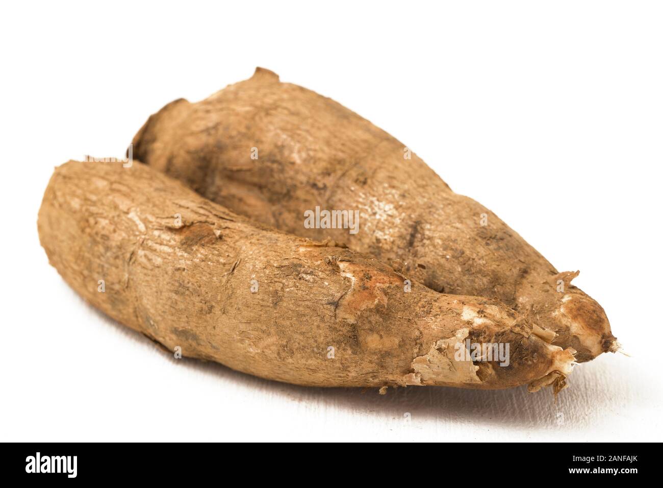 Fresh Cassava root isolated on a white background Stock Photo - Alamy