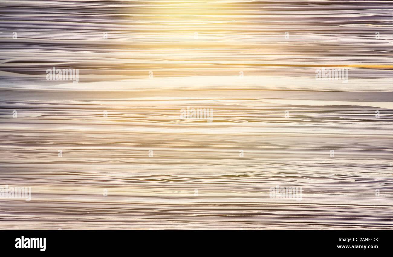 A Stacking Of Paper Sheets And Files With Top Flare Light Stock Photo a-stacking-of-paper-sheets-and-files-with-top-flare-light-stock-photo