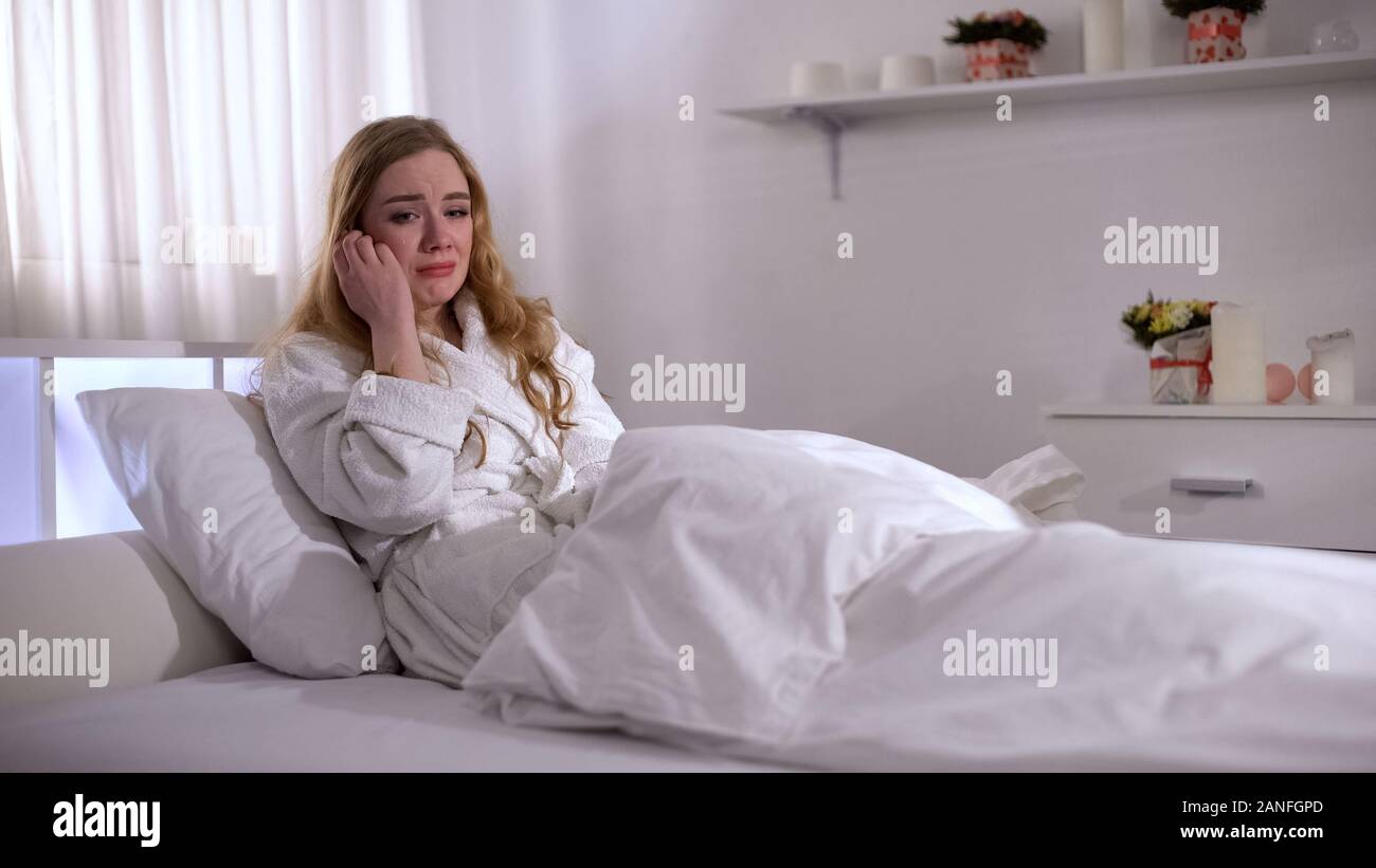 Pretty girl talking on phone and crying desperately, depressed with ...