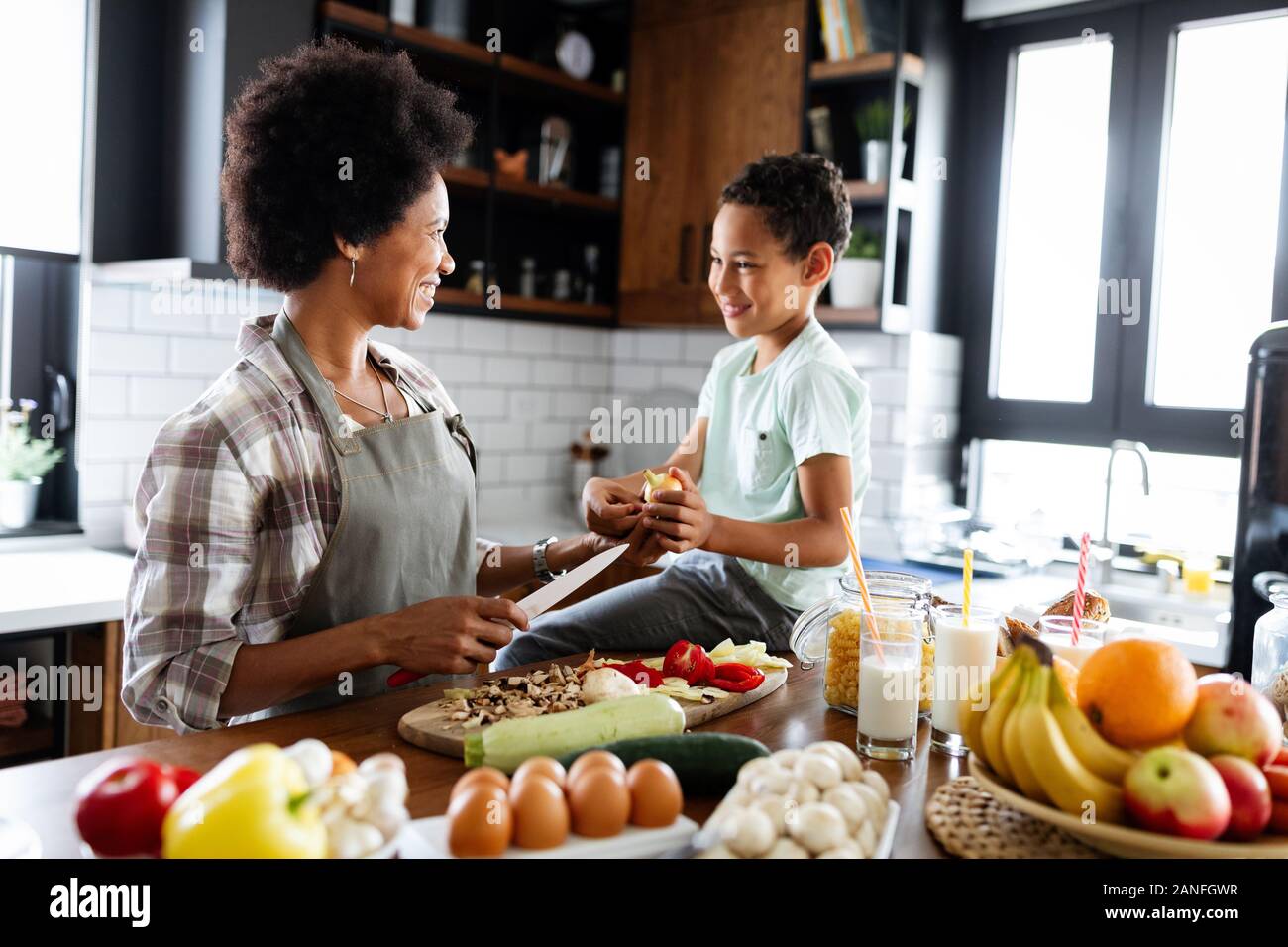 Happy mother and children in the kitchen. Healthy food, family, cooking ...