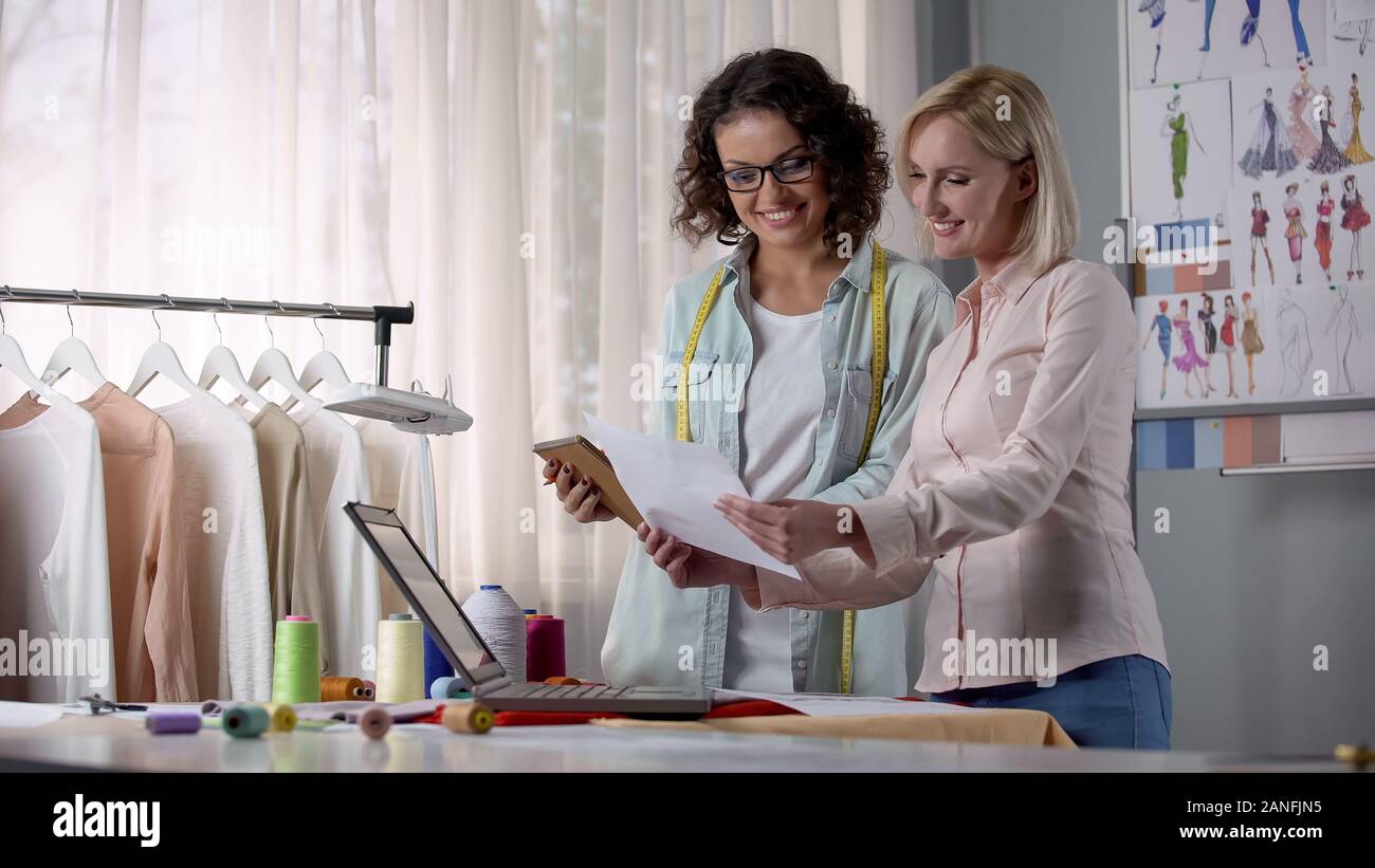 Cheerful female designers working on creation of new clothes line ...