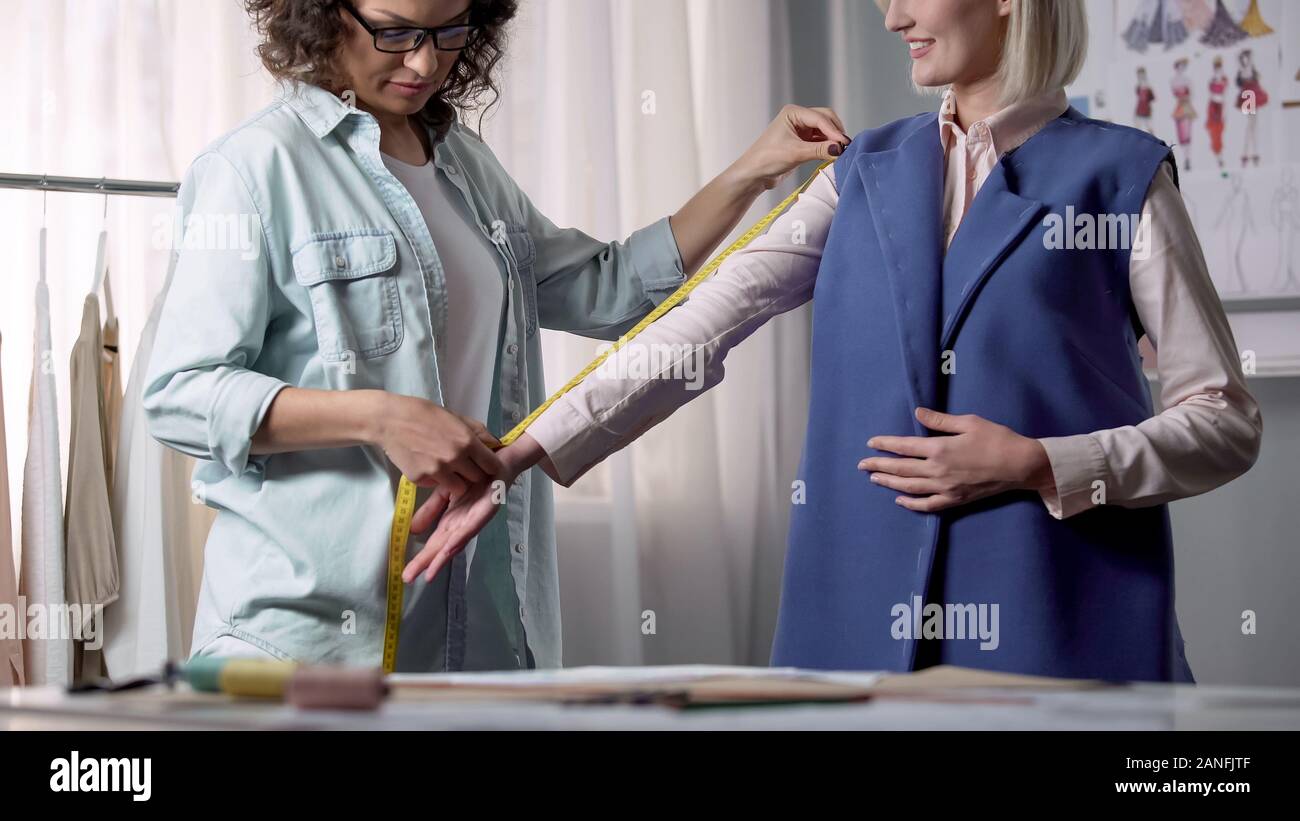 Couturier taking production order for enterprise uniforms, individual ...