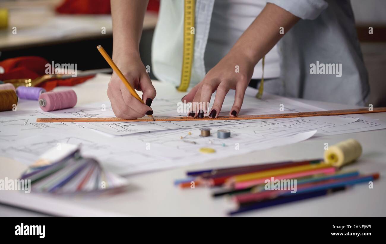 Designer drawing template for sewing new dress according to her ...