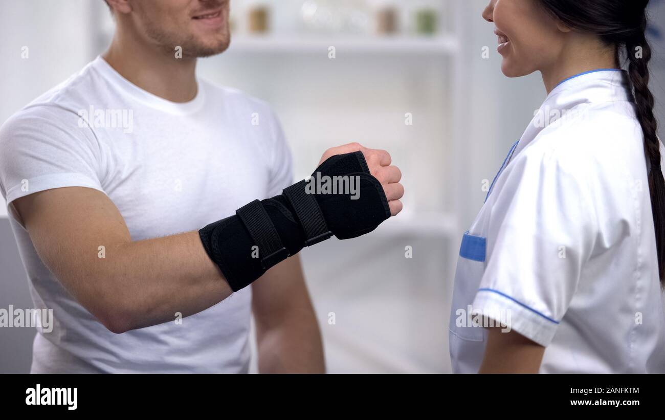 Patient in titan wrist brace showing hand doctor, rehabilitation after ...