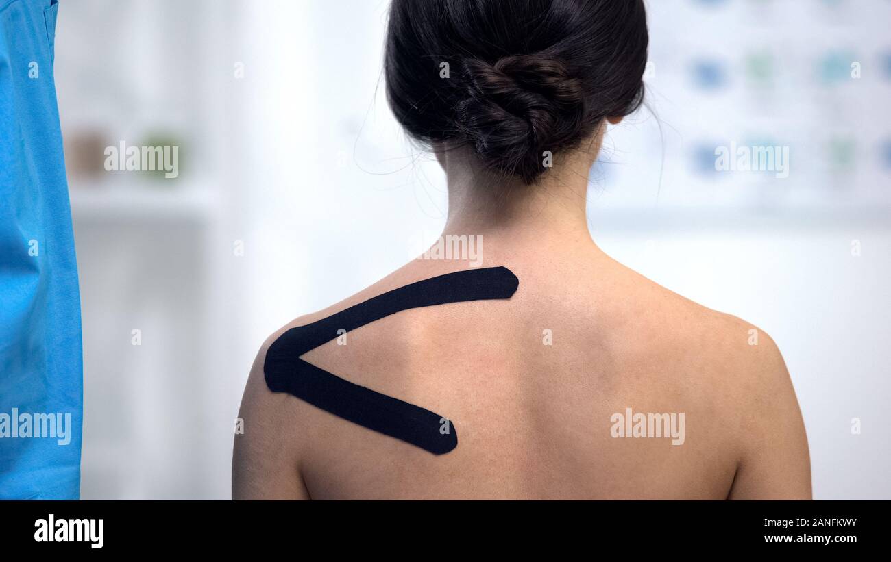 Female patient with applied Y-shaped tape on shoulder, alternative ...