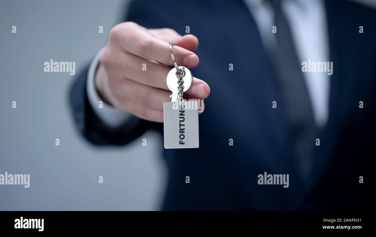 Fortune word on keychain in businessman hand, key secret of successful ...
