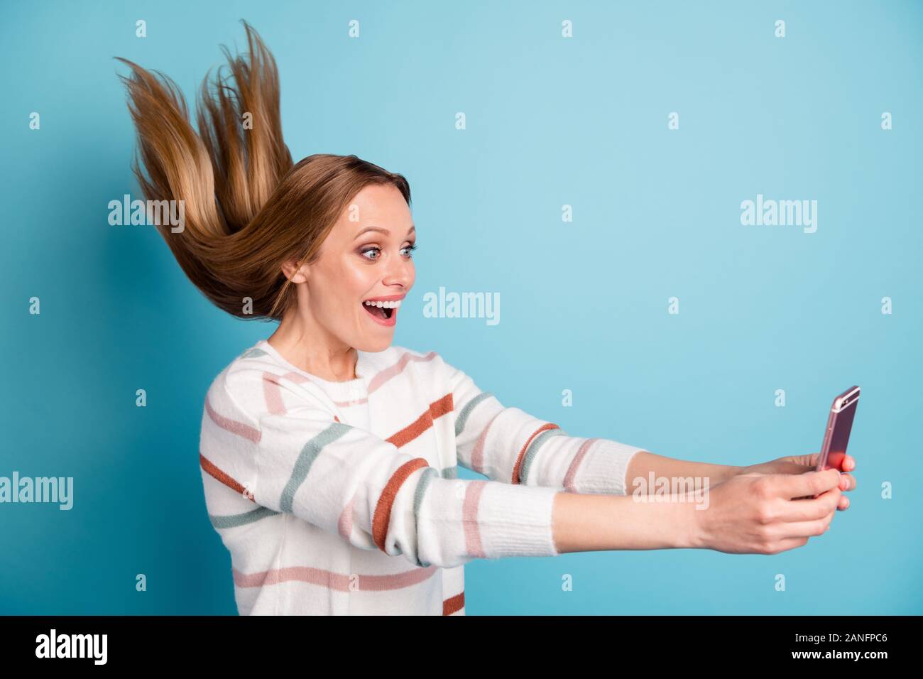 Photo of cheerful pretty cute nice girl with hair blown by gust of wind ...