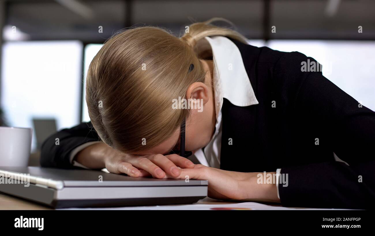 Female employee lying on laptop, annoyed with work, nervous breakdown ...