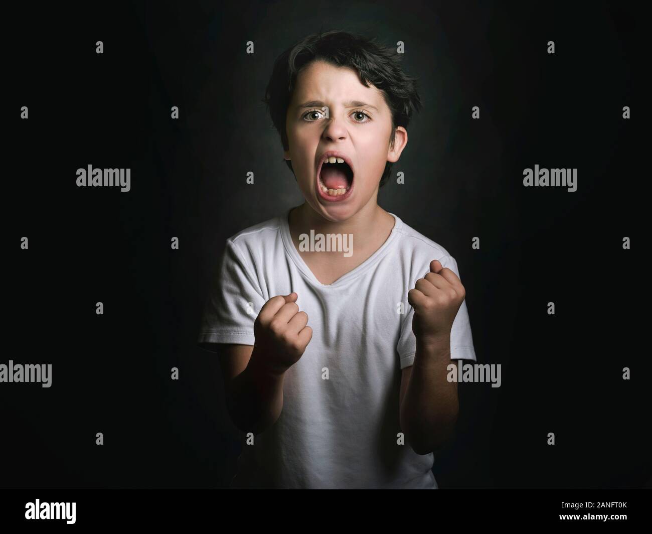 angry boy on black background Stock Photo - Alamy