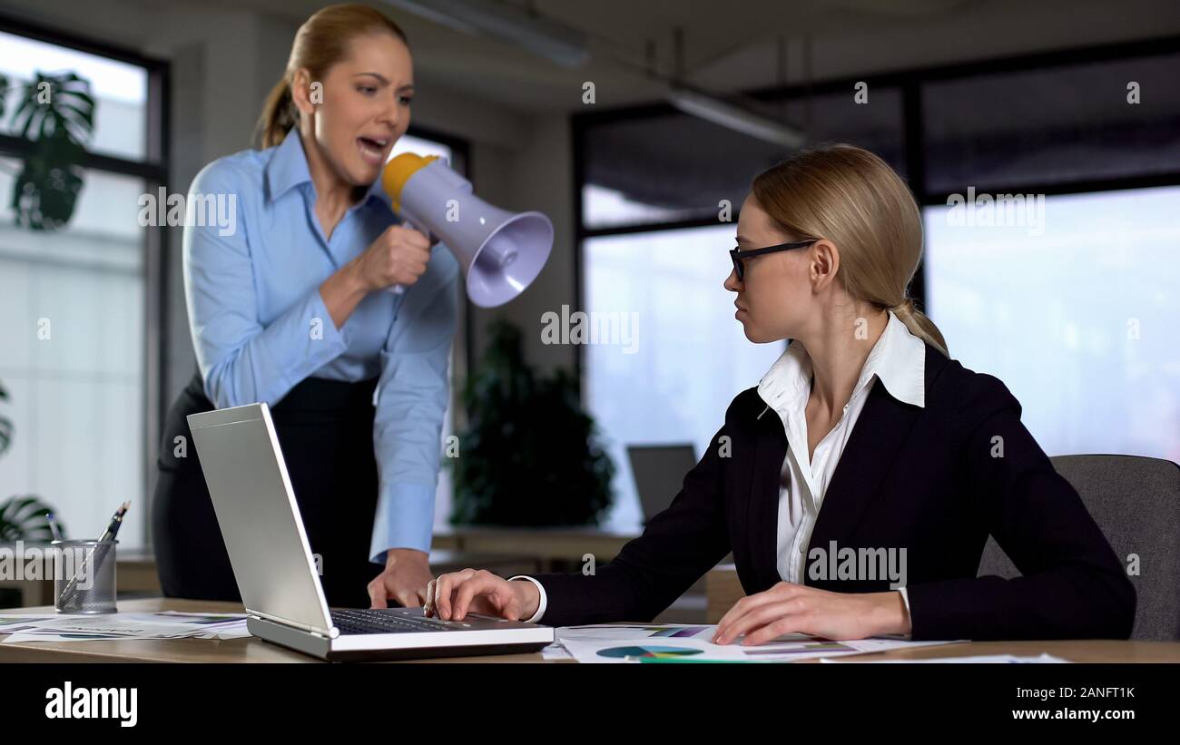Lady boss shouting with megaphone at colleague, authoritarian ...