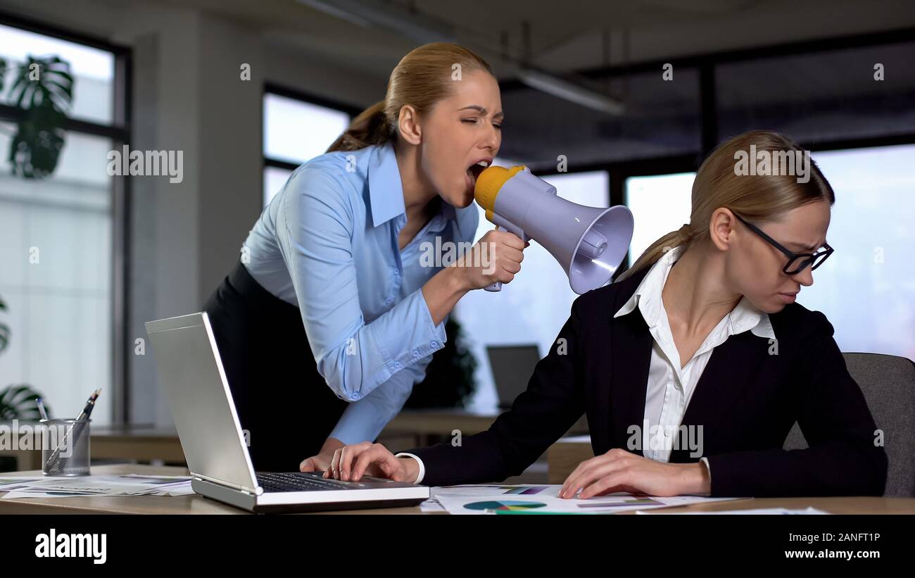 Female boss screaming with megaphone at colleague, authoritarian ...