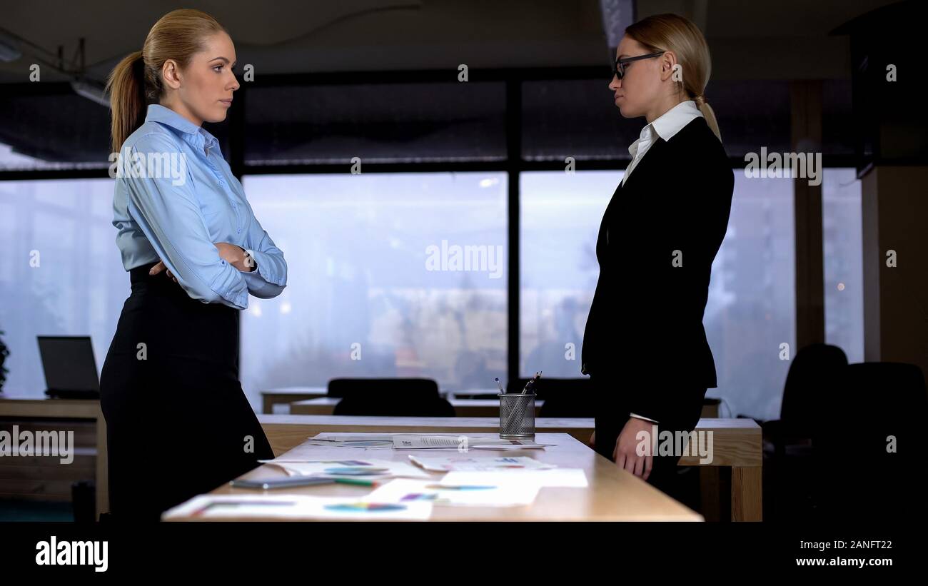 Opponents looking at each other, standing in office, business rivalry ...