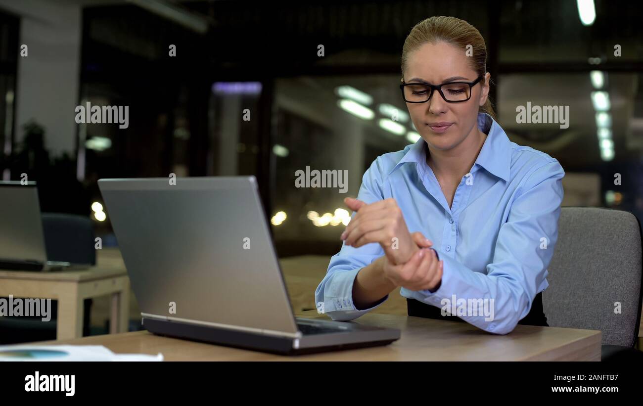 Woman feels wrist pain caused by excessive use of laptop, carpal tunnel ...