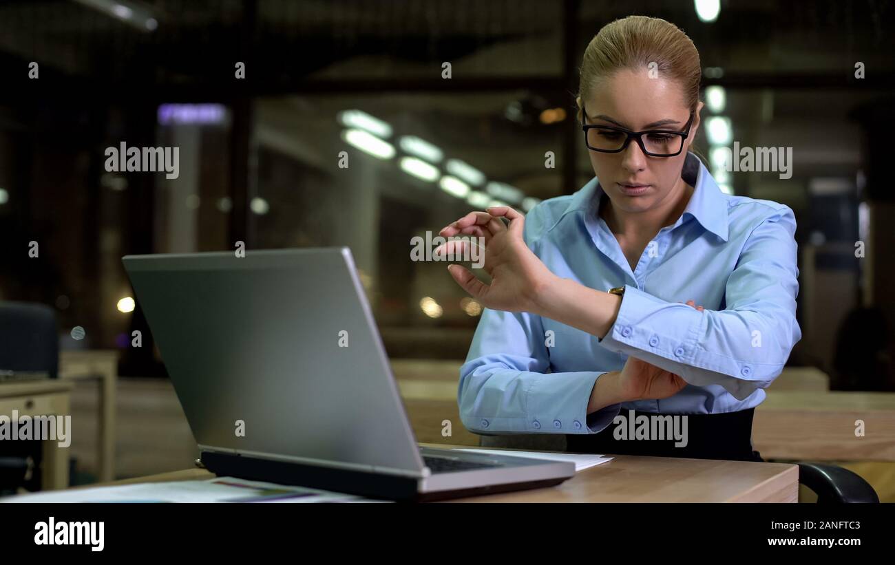 Woman checking clock office hi-res stock photography and images - Alamy