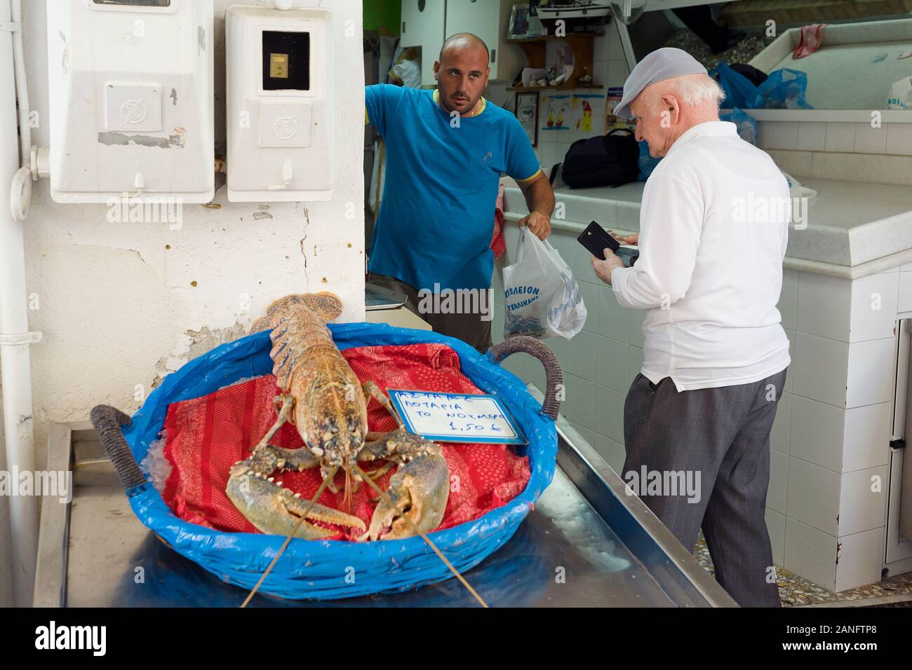stall of a fish merchant in an alley of Ermoupolis in Syros island ...