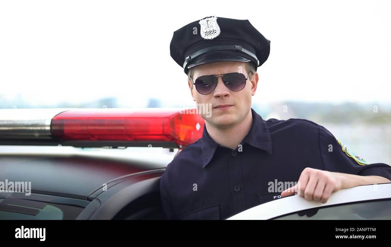 Handsome caucasian police officer standing hi-res stock photography and ...