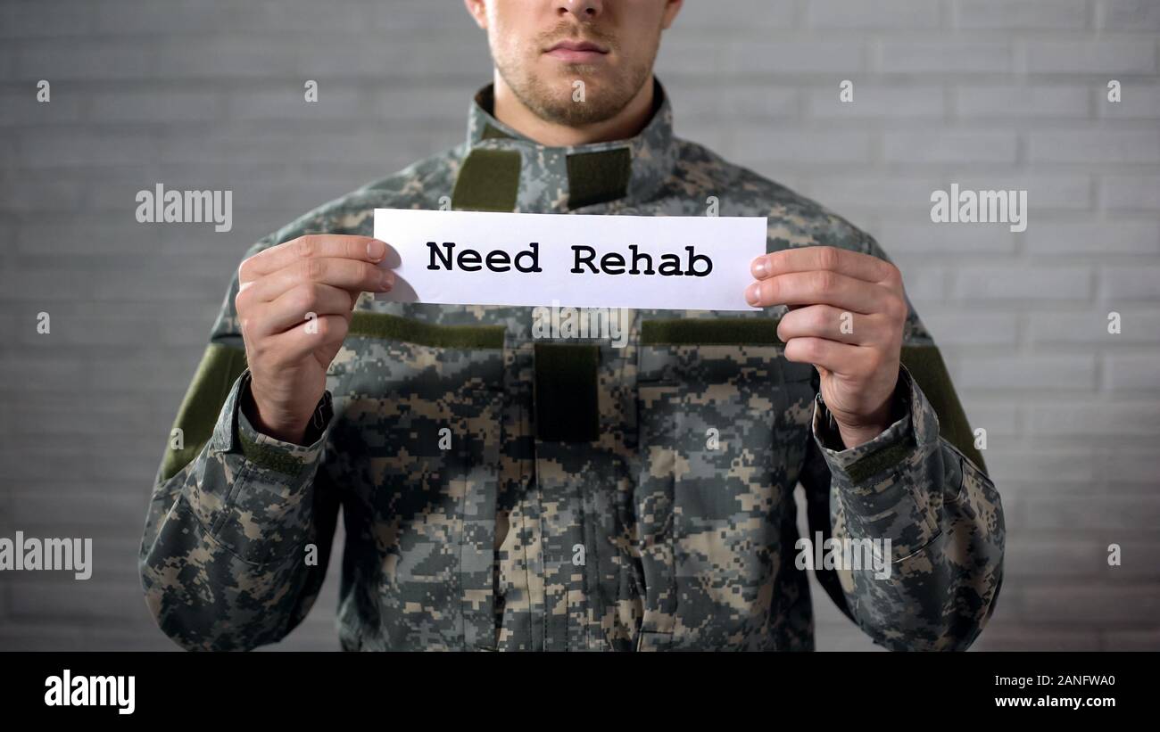Need rehab words written on sign in hands of male soldier, social ...