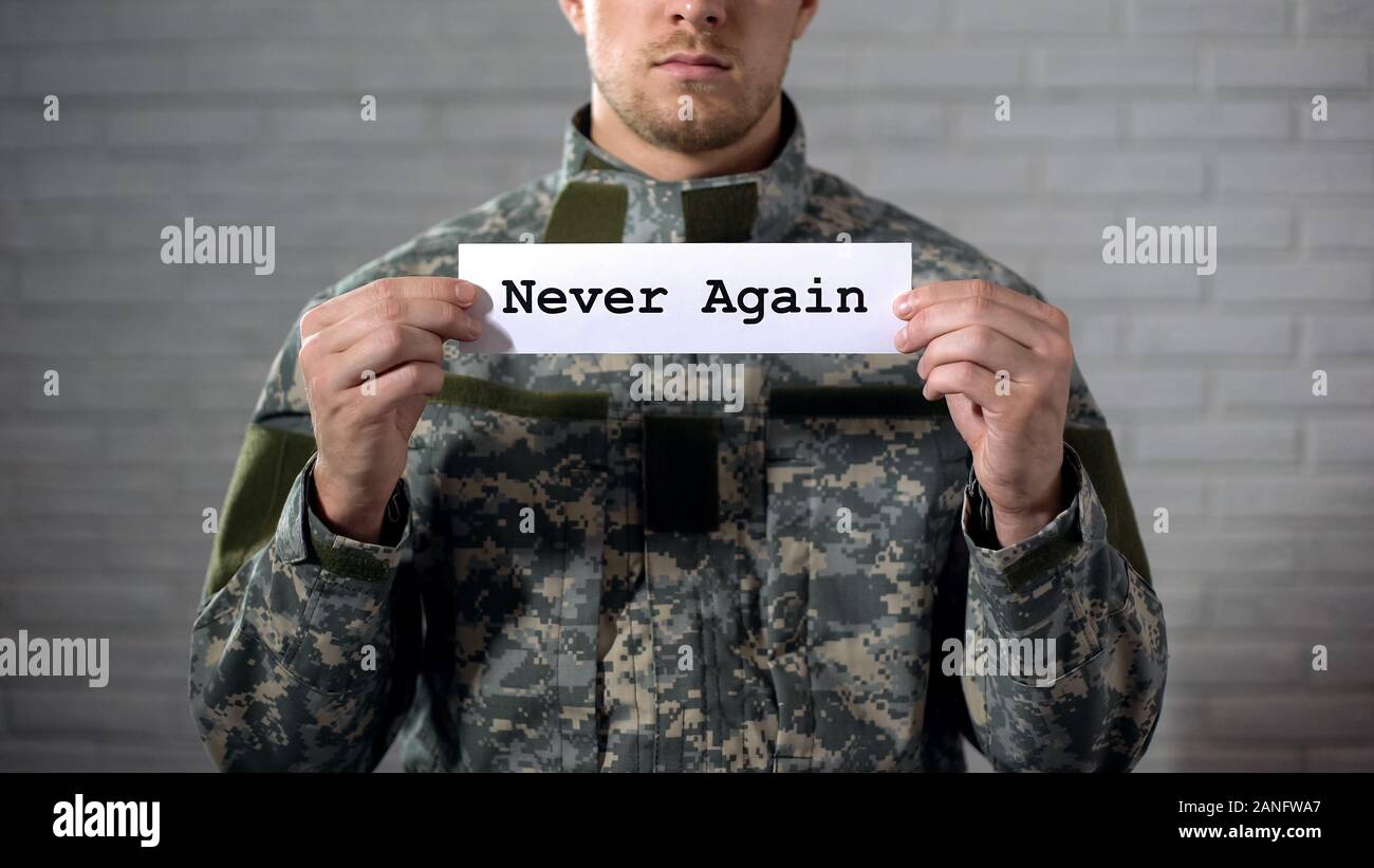 Never again word written on sign in hands of soldier, people against ...