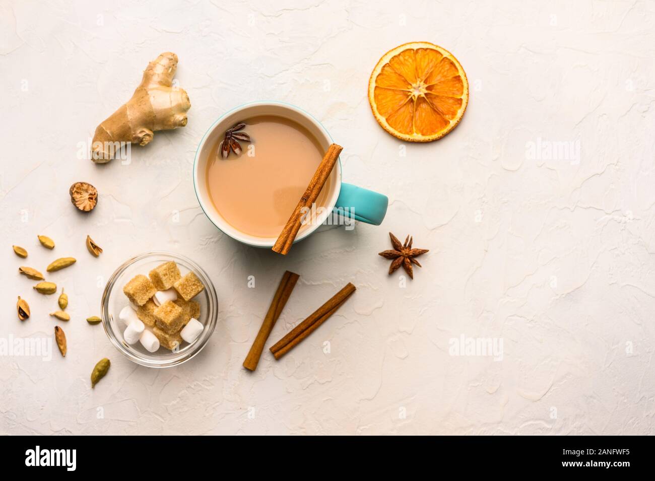 Traditional Indian masala tea chai with milk and spices on white ...