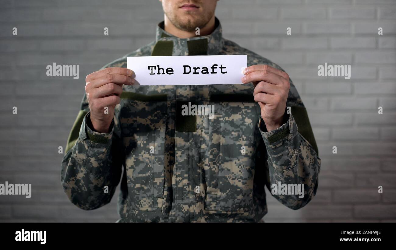The draft written on sign in soldier hands, compulsory military service ...